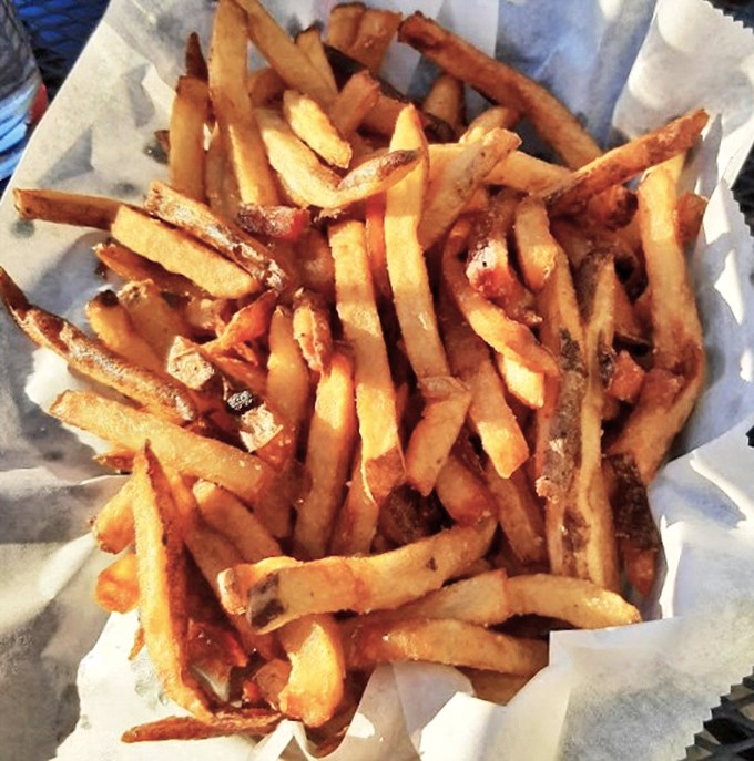 Hand-cut fries that achieve the golden trifecta: crispy exterior, fluffy interior, and just enough salt to make you reach for your beer.