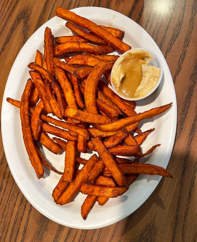 Sweet potato fries with a side of attitude. That dipping sauce isn't just an accompaniment&mdash;it's a flavor wingman on your journey to satisfaction.