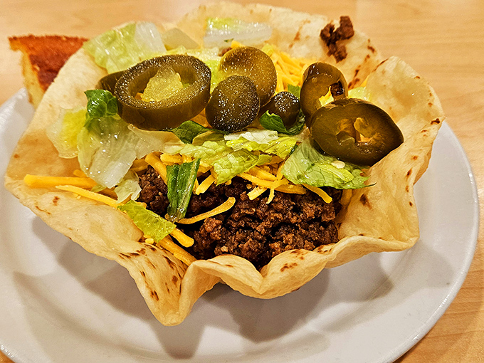 This taco salad bowl with seasoned beef, cheese, and jalape&ntilde;os sits in its crispy tortilla shell like edible art you're about to devour.