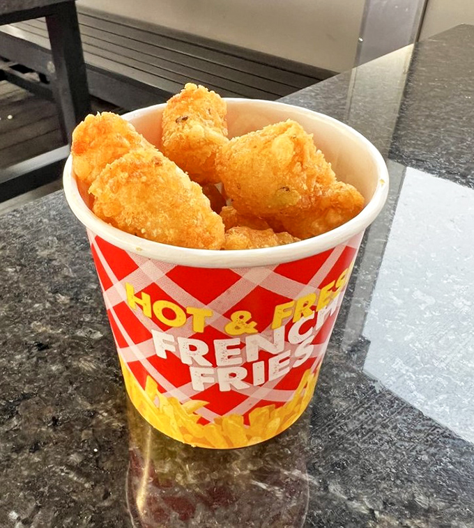 Golden, crispy tater tots that crackle with each bite &ndash; the perfect sidekick to any burger adventure. Simple perfection in a nostalgic red-checkered container.