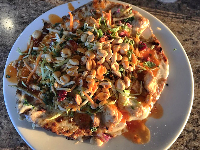 This isn't just pizza; it's a flavor expedition topped with peanuts, fresh herbs, and a sauce that would make Bangkok proud&mdash;fusion food that actually works.