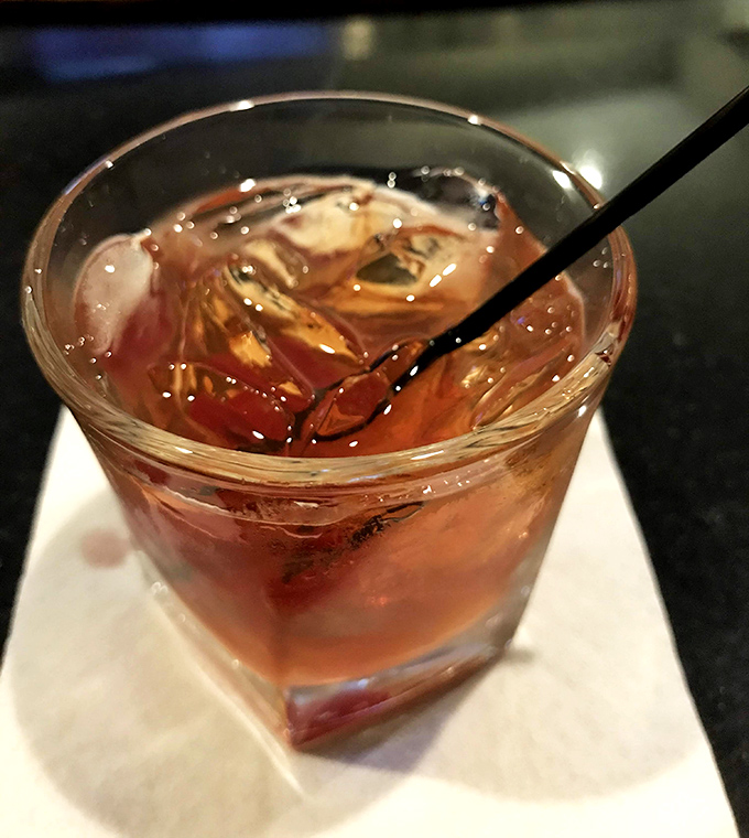 This isn't just a cocktail &ndash; it's liquid amber contemplation in a glass, with ice cubes that clink like tiny approval bells.