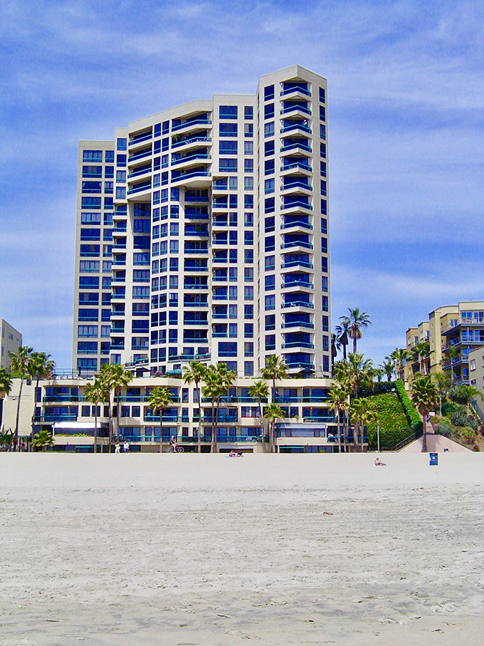 The Ocean Club rises from the sand like a blue-and-white chess piece, where residents enjoy front-row seats to nature's greatest show: the Pacific sunset.