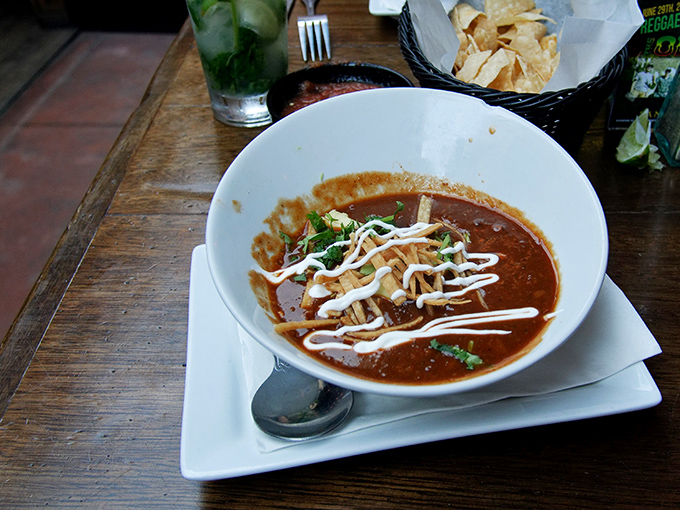 This tortilla soup isn't just served&mdash;it's presented with artistic drizzles of crema that turn comfort food into a bowl of Mexican expressionism.