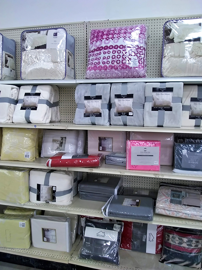 Bedding and linens stacked with military precision&mdash;because even secondhand dreams deserve a soft place to land.