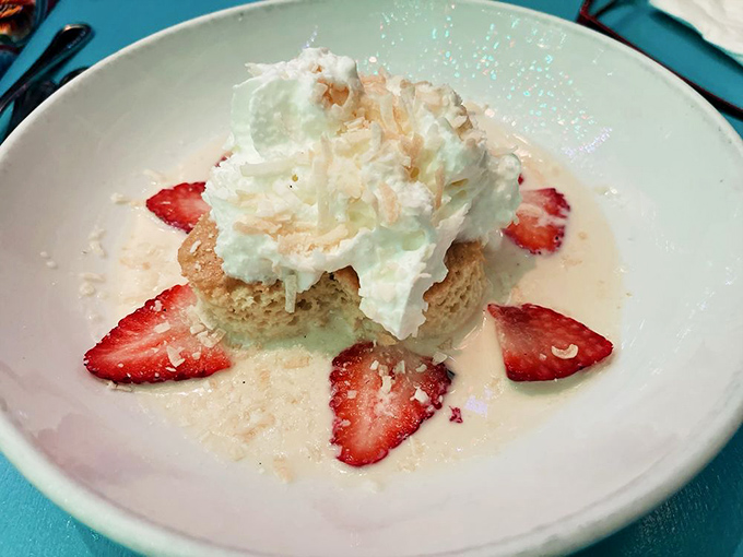 Tres leches cake with strawberries and coconut&mdash;where "death by dessert" becomes less threat and more bucket list achievement.