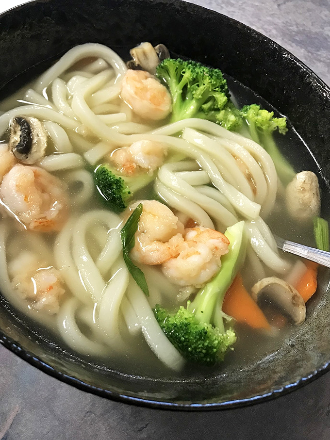 A soup that speaks volumes &ndash; clear broth with plump shrimp and udon noodles thick enough to satisfy but tender enough to slurp with dignity.
