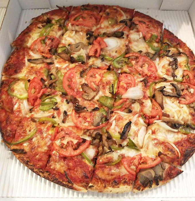 A vegetable pizza that doesn't feel like punishment. Fresh tomatoes, green peppers, and mushrooms prove eating your veggies can be indulgent.