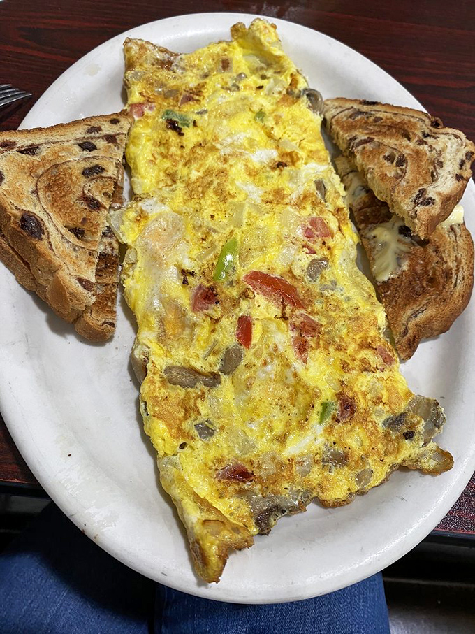 Veggie omelet with raisin toast shows healthy choices can still satisfy your breakfast soul completely. 