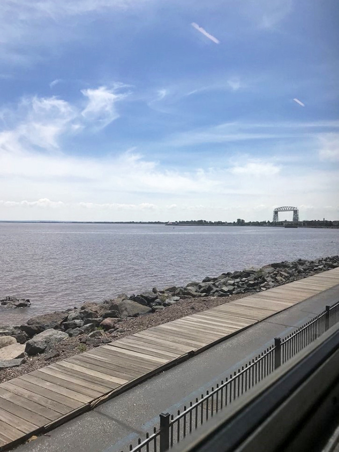 Lake Superior stretches to the horizon like a freshwater ocean, with Duluth's iconic lift bridge standing sentinel in the distance.