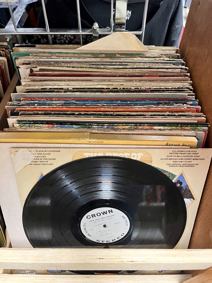Vinyl treasures stacked like pancakes of musical history. Each record a time machine to when album art was as important as the music itself.