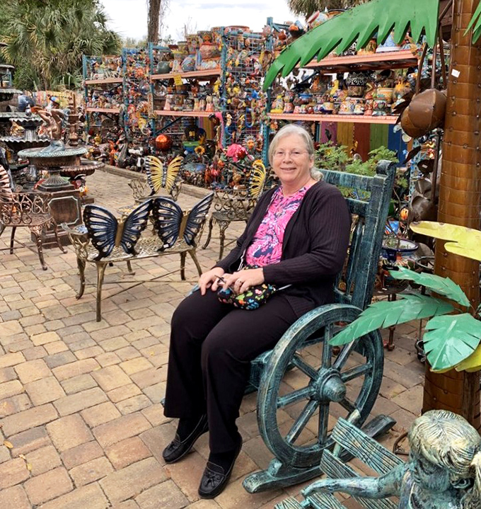 Visitors discover the perfect spot to rest among the artistic chaos, surrounded by butterfly benches and whimsical creations.