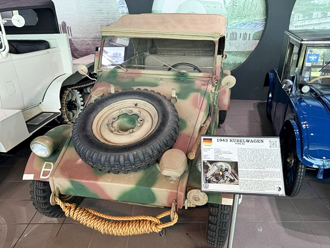 This camouflaged Kubelwagen sits stoically, a utilitarian reminder of how automotive innovation served military purposes during wartime. History on wheels.