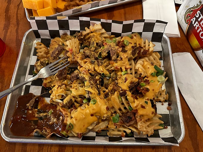 Waffle fries dressed for success with cheese, meat, and green onions. Proof that sometimes the best canvas is a humble potato.