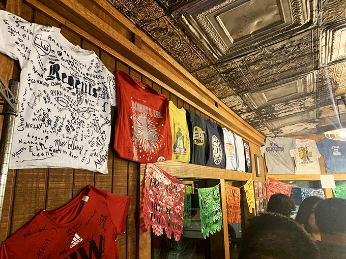 T-shirts on display tell the story of a restaurant that's become more than a meal—it's become a souvenir-worthy memory.