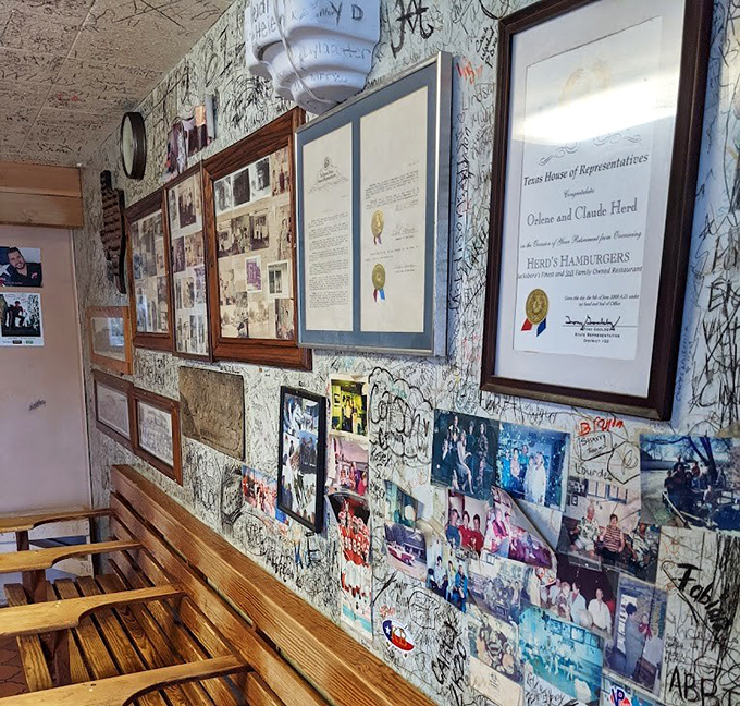Awards and memories share wall space with thousands of signatures. Not a marketing strategy&mdash;just the natural accumulation of burger-induced joy.