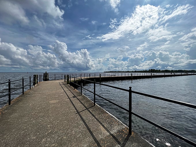 Edenton's waterfront pier stretches toward infinity under dramatic clouds that look like they're auditioning for a role in a Tennessee Williams play.