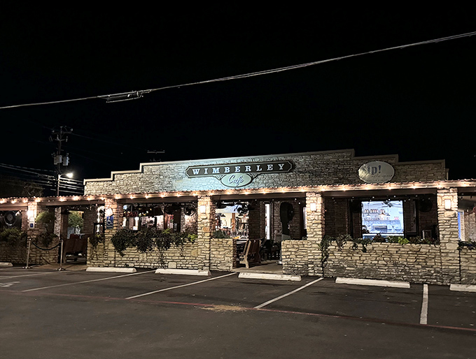 Wimberley Cafe glows with evening promise, its limestone walls illuminated like a beacon for hungry Hill Country explorers.