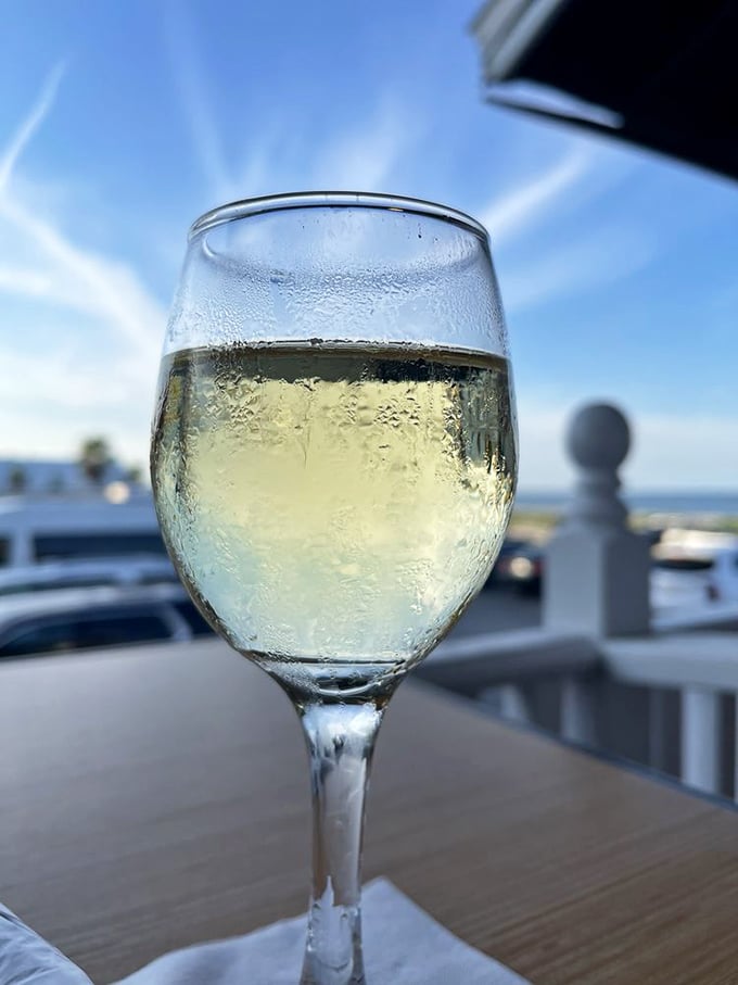 A glass of chilled white wine with the ocean as your backdrop – some moments are worth savoring slowly.
