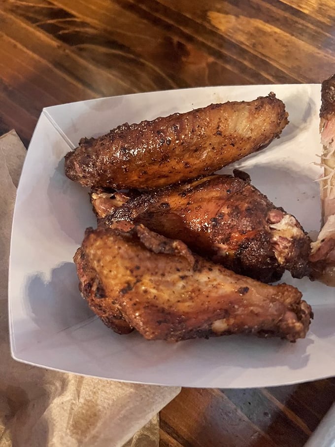 Wings that have clearly been introduced to smoke and spice in the most delicious way possible—a crispy, burnished masterpiece.
