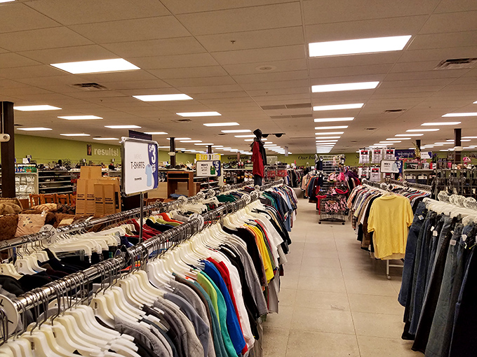 The view down the aisle—where organized racks create a thrifter's yellow brick road to fashion finds and household treasures.