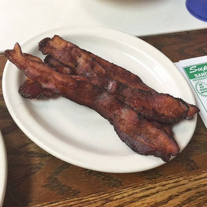 Bacon strips lined up like crispy soldiers ready to report for breakfast duty on your plate.