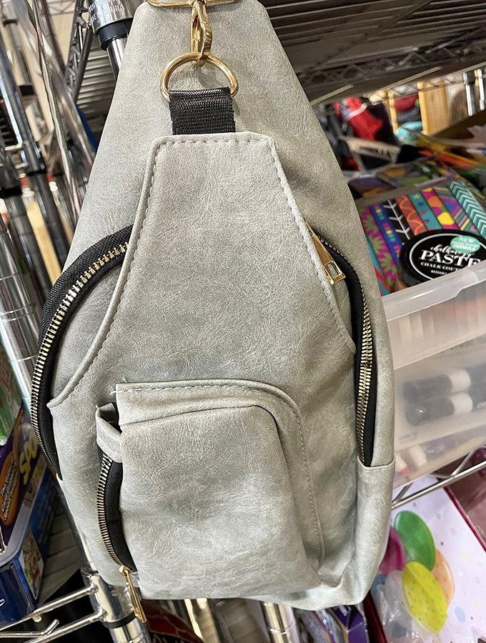 This sleek gray crossbody bag looks barely used. One shopper's impulse buy becomes another's everyday essential.