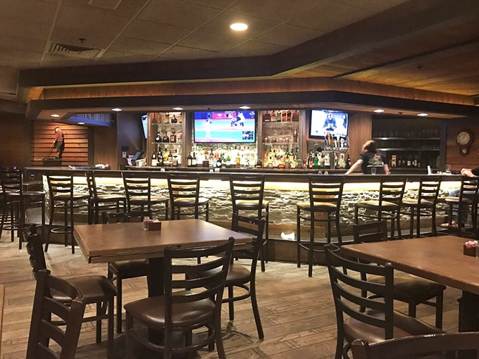 The bar area combines rustic charm with modern comfort for the perfect dining atmosphere. 