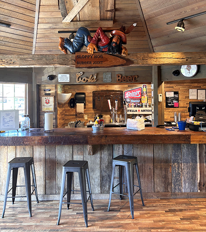 The bar where beer flows and conversation follows. That carved wooden hog watching from above has seen some stories worth telling.