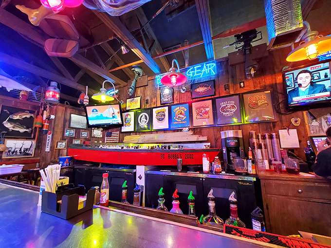 The bar area glows with neon promise, like a lighthouse guiding hungry sailors to safe harbor and cold beer.