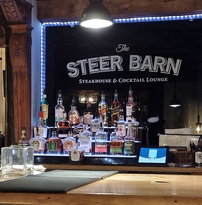 The bar area glows with promise, a woodsy sanctuary where spirits meet spirits and the day's troubles dissolve faster than ice in whiskey.