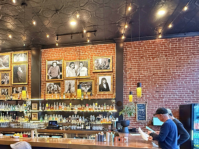 The bar area doubles as a gallery wall, showcasing photographs that tell stories while you wait for the main attraction.