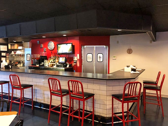 The bar area's bright red accent wall and comfortable seating make waiting for a table feel less like purgatory and more like a happy hour bonus.