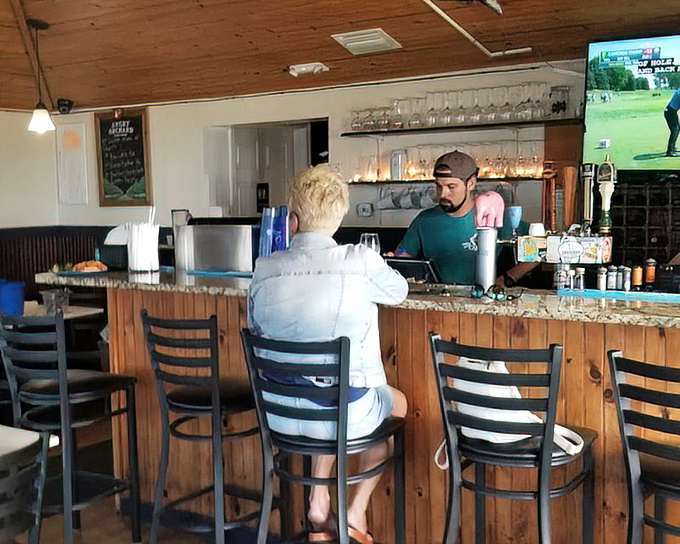 The bar area offers front-row seats to the culinary action, where cold drinks and local gossip flow freely.