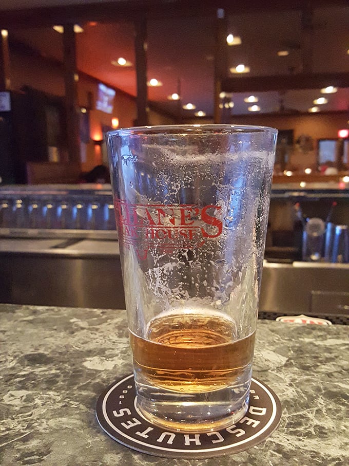 A nearly empty beer glass tells the story of a good meal in progress. The condensation writes "time well spent" on the Culhane's branded glass.