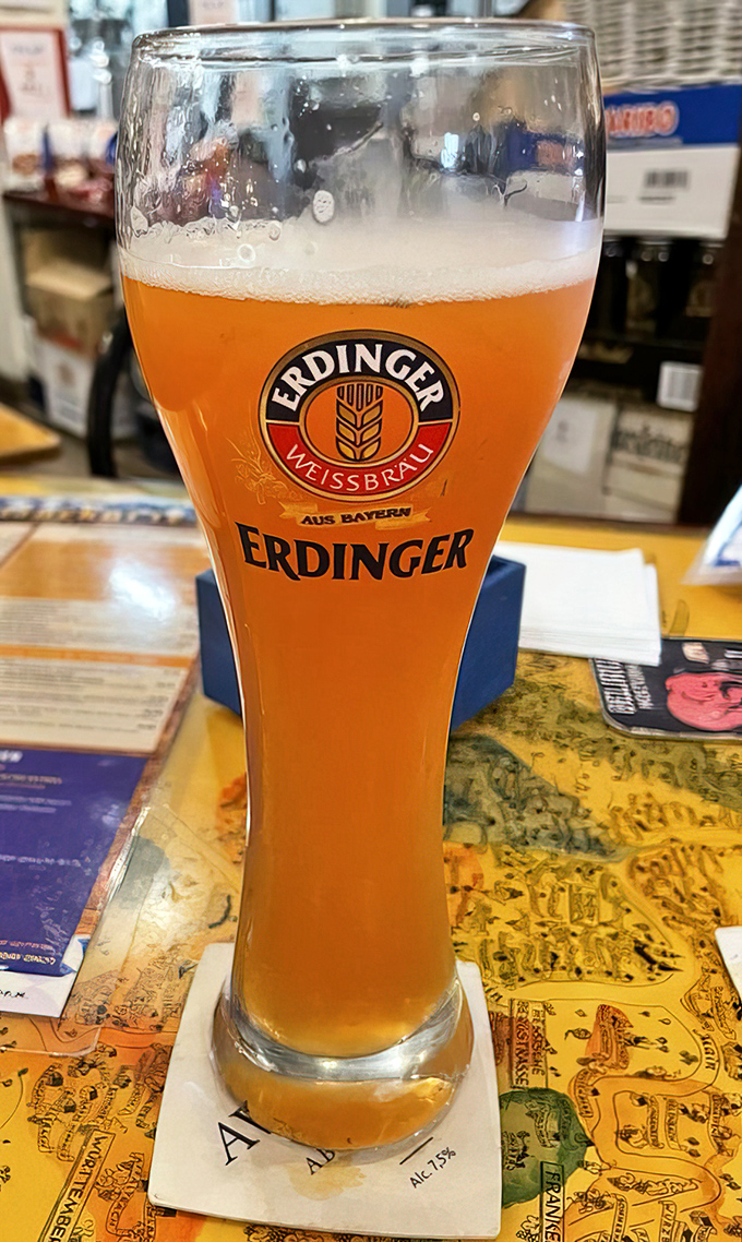 An Erdinger Weissbier standing tall and proud &ndash; liquid sunshine in a glass that practically yodels with every sip.