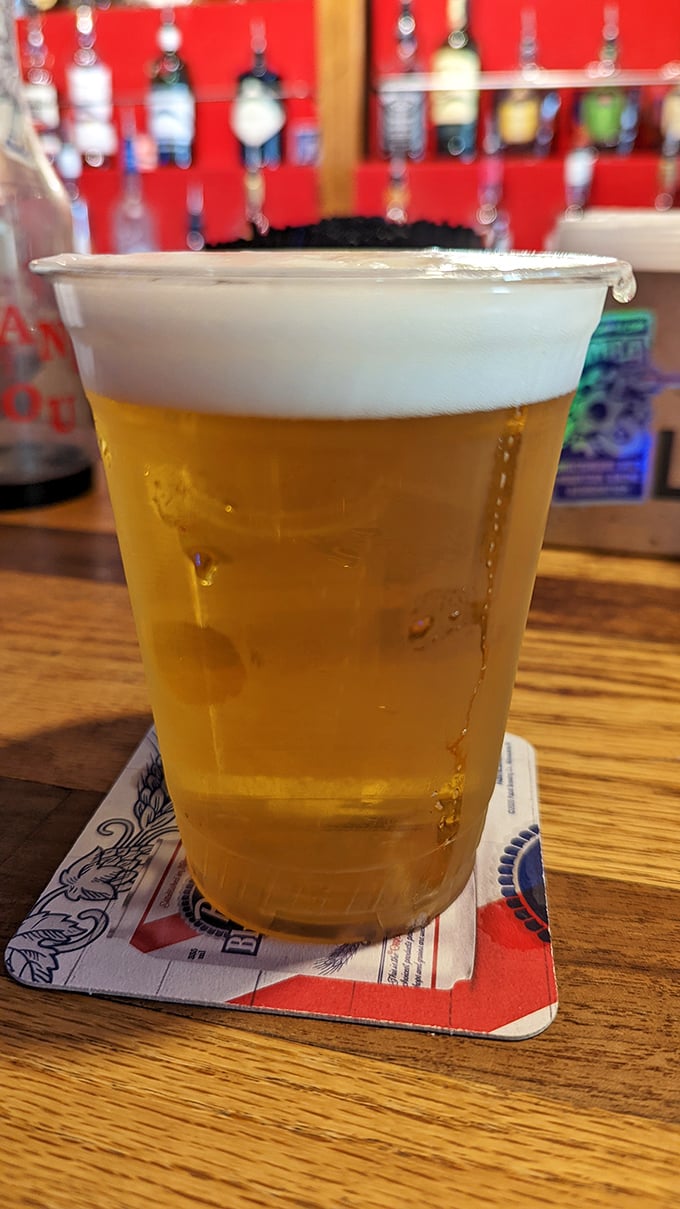 A cold beer in a plastic cup &ndash; the universal symbol for "relax, you're among friends now." Simple pleasures are often the most profound.