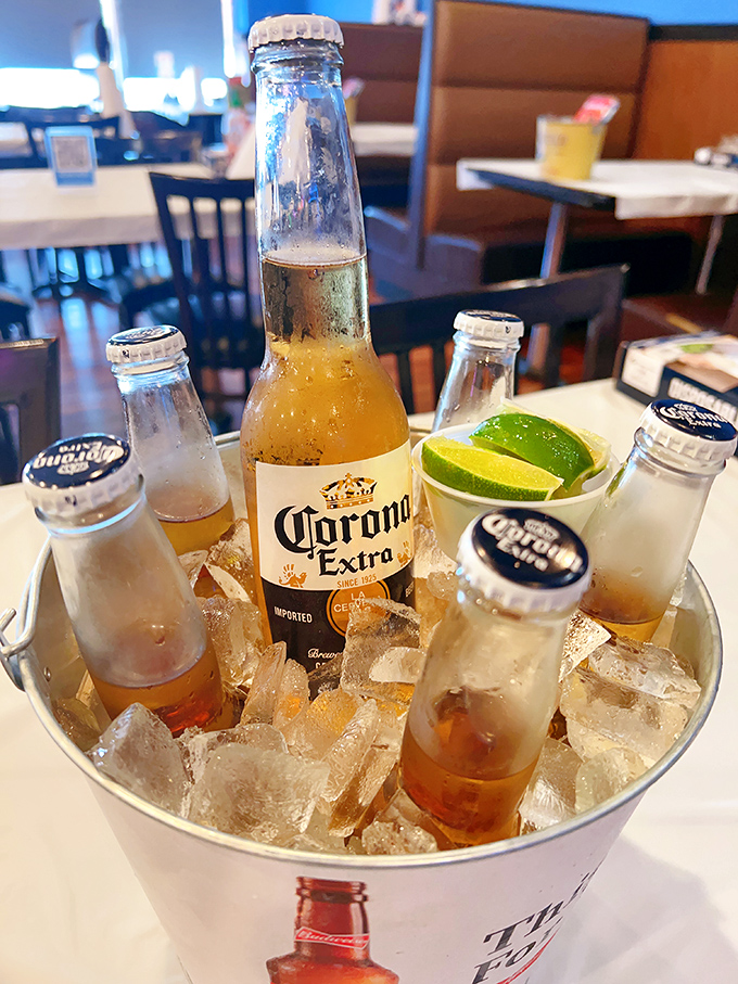 Cold beers nestled in ice, waiting to extinguish the pleasant fire of Cajun spices. The lime wedges aren't just garnish&mdash;they're essential flavor companions.