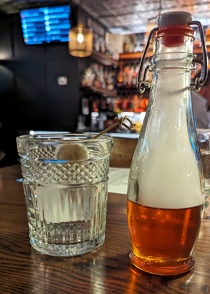 Someone's treating their water to a fancy bottle experience while that amber beverage waits its turn patiently.