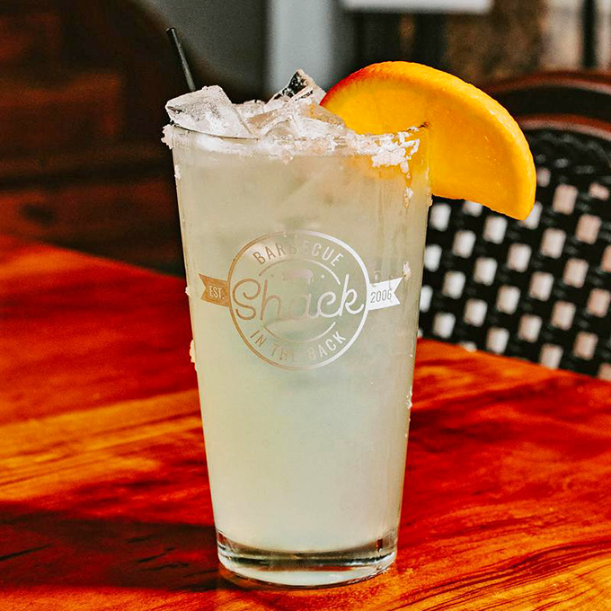 A frosty glass with salt rim and orange garnish&mdash;because proper hydration is essential when embarking on a serious barbecue adventure.