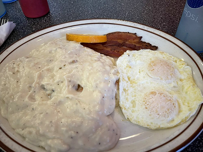 Country gravy blankets these eggs and bacon like a comforting hug from your favorite grandma who never counted calories on your behalf.