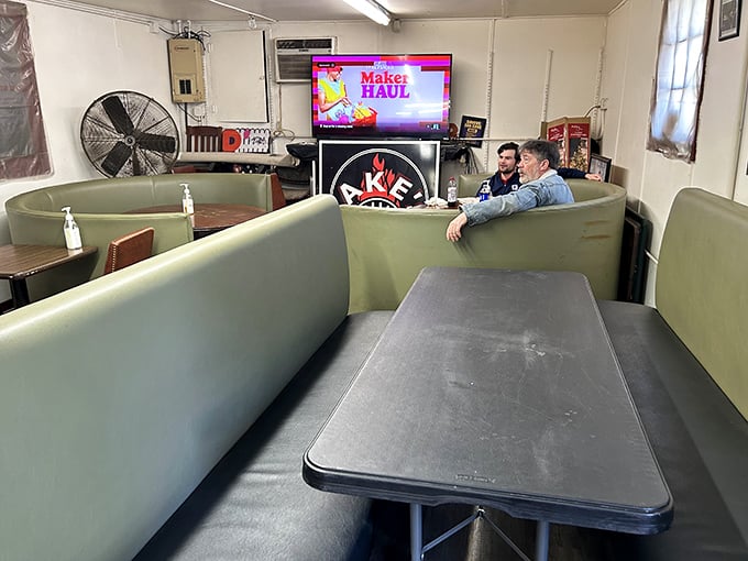 Green vinyl booths and simple tables say, "We spent our money on the smoker, not the furniture." Priorities in perfect order.