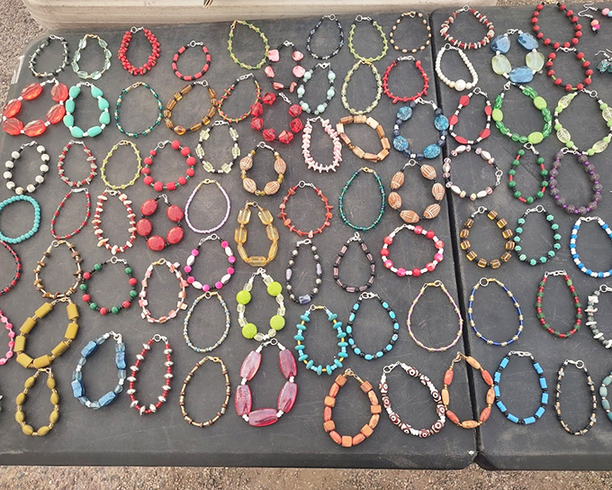 A kaleidoscope of beaded bracelets spreads across the table like a color wheel. Wearable art at prices that won't break the bank.