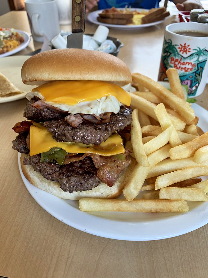This isn't just a burger – it's a towering monument to beef artistry, with cheese melting like sunshine and fries that demand to be noticed.