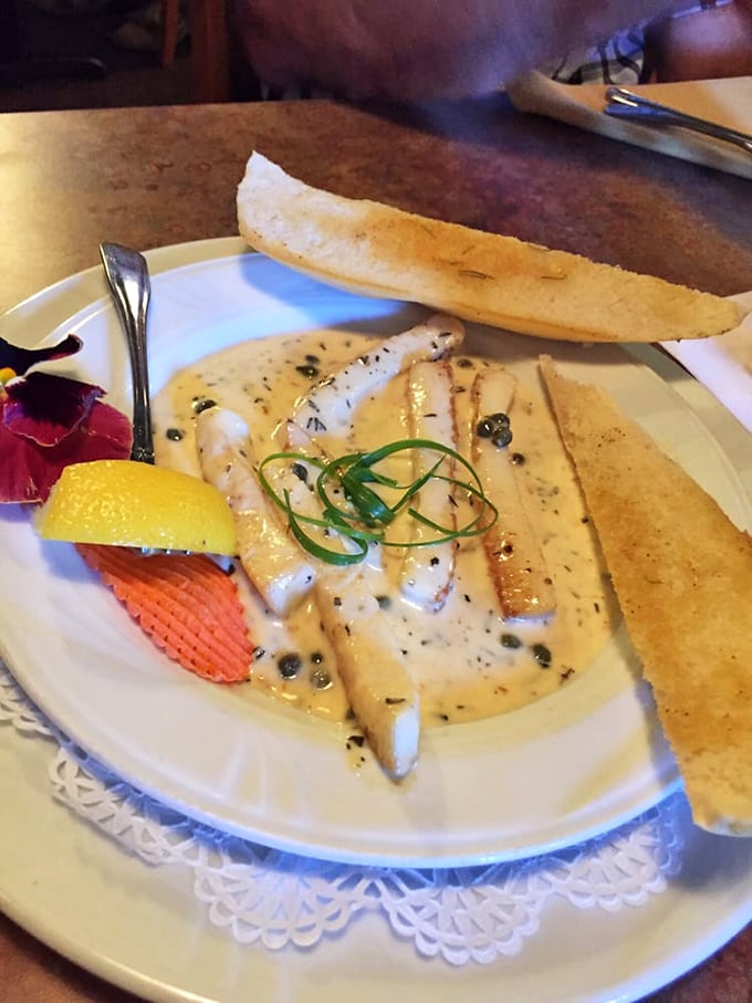 Delicate white fish fillets bathed in a sauce that whispers of butter and capers&mdash;proof that sometimes the simplest preparations create the most profound flavors.