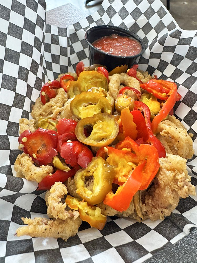 Fried calamari mingling with colorful peppers—a carnival of textures and flavors that proves seafood can party with the best of them.