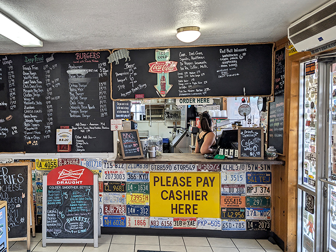 Where culinary dreams become reality, one order at a time. The command center of flavor, framed by the establishment's signature license plate decor.