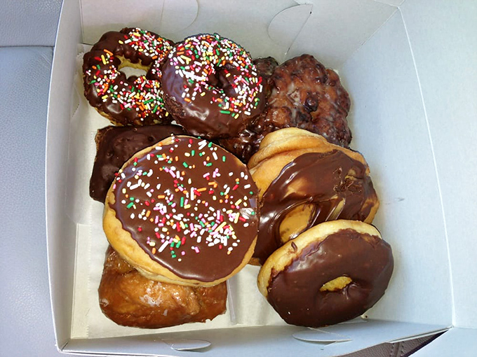 A box of possibilities. The chocolate-glazed with sprinkles isn't just a donut &ndash; it's childhood nostalgia in edible form.