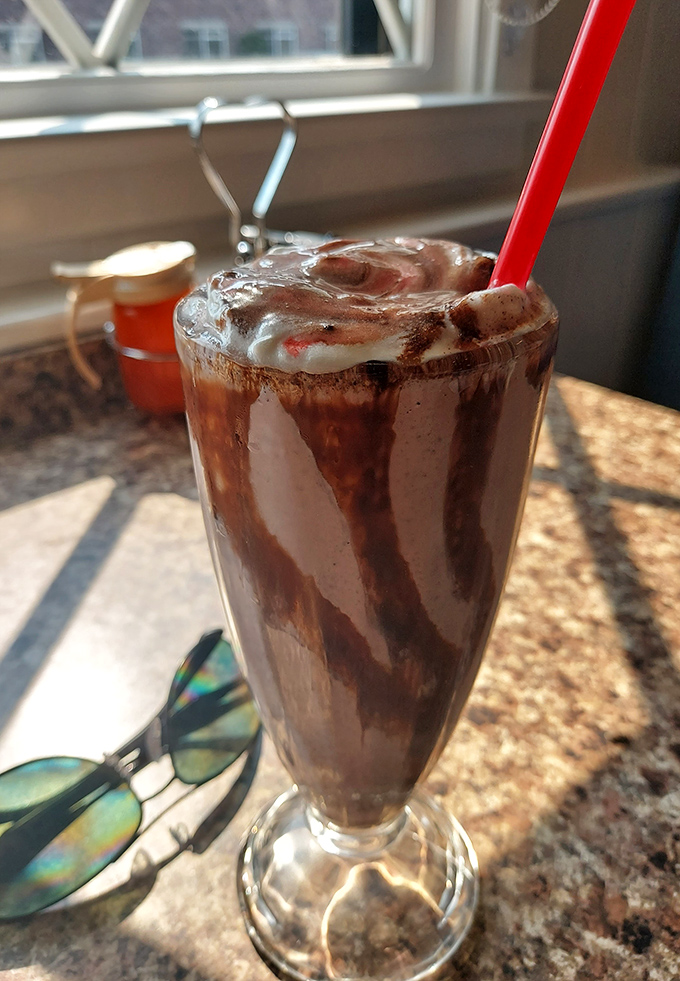 This chocolate milkshake isn't just thick&mdash;it's contemplating a career in solid geometry. The straw stands at attention like a soldier.