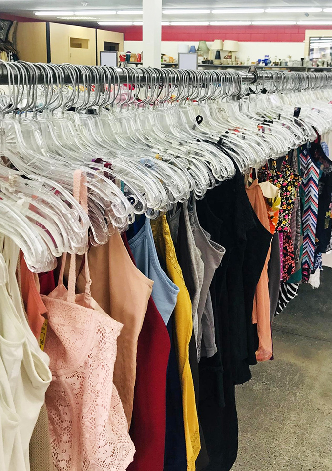 Racks of summer dresses and blouses hang like colorful flags, each hanger a promise of style reinvention on a budget.